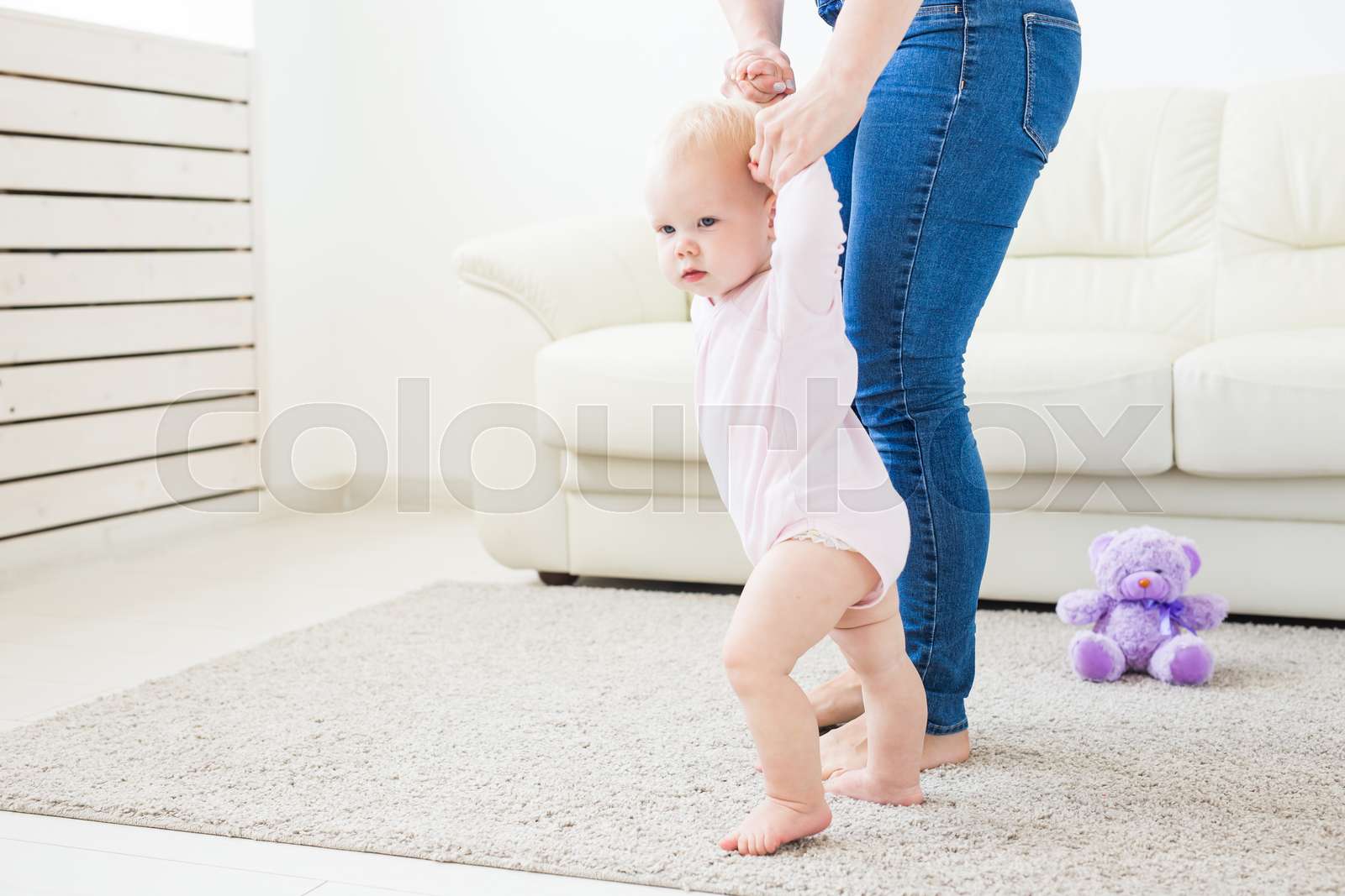 First steps. Little baby girl learning to walk. | Stock image | Colourbox