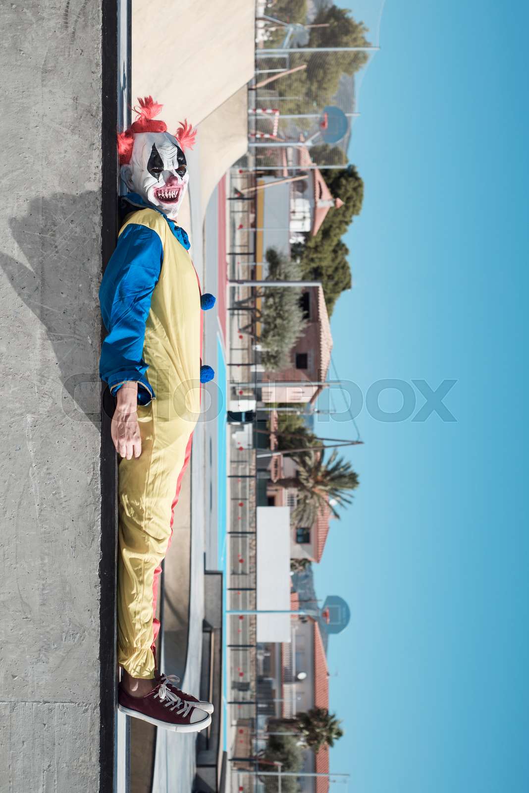 scary clown lying down outdoors | Stock image | Colourbox