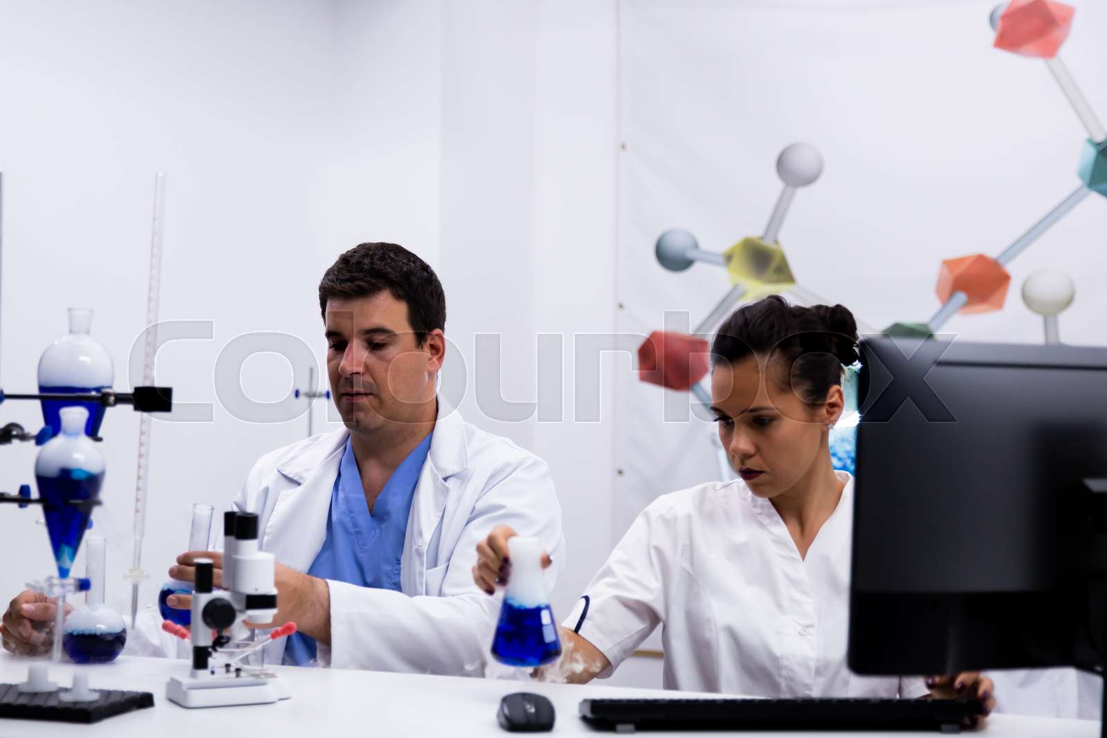 Team of researchers wearing their coat in research laboratory | Stock ...