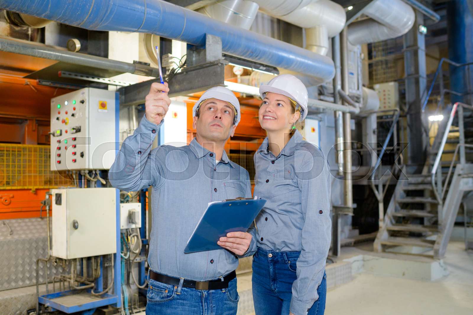 industrial pipe maintenance worker showing apprentice | Stock image ...