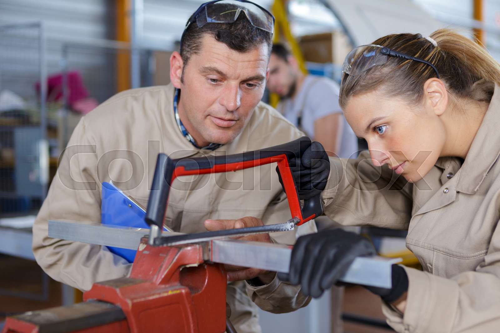 female worker cutting box section steel | Stock image | Colourbox