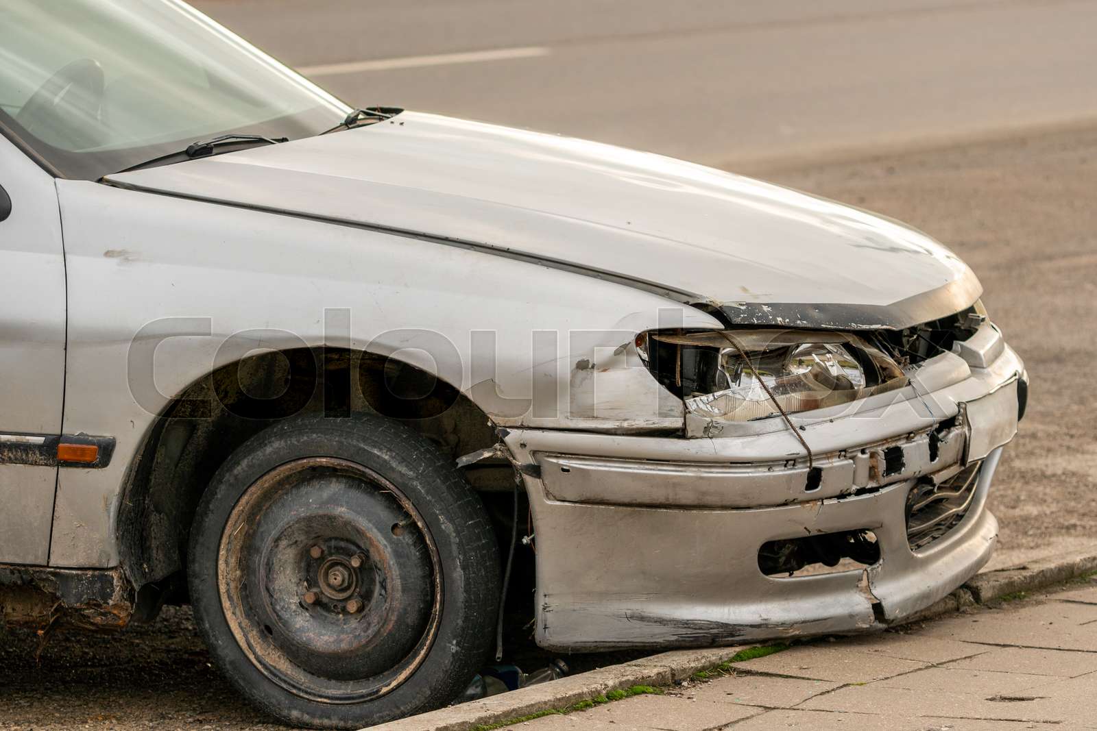 Damaged car on a city street | Stock image | Colourbox
