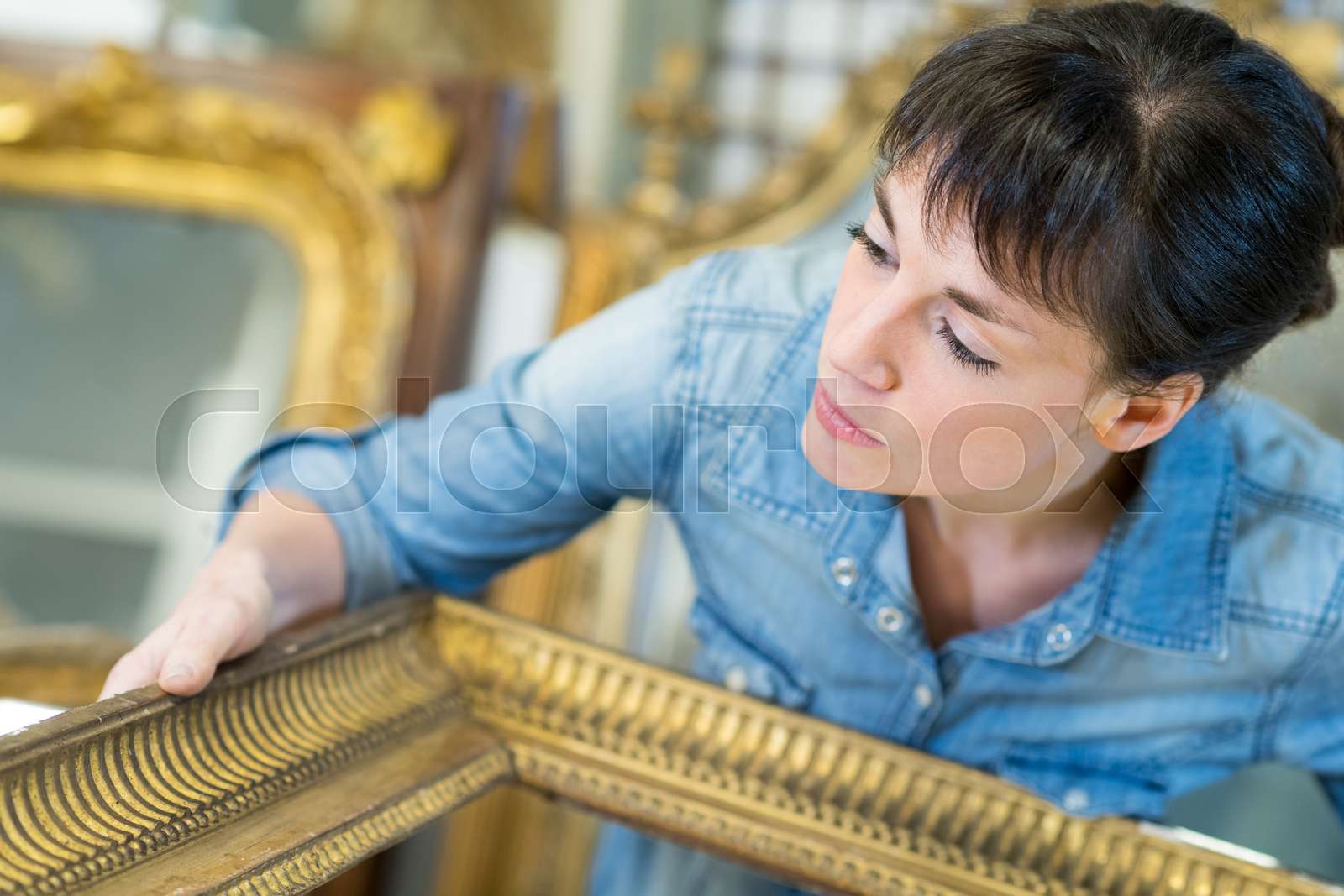 female customer buying a frame in atelier | Stock image | Colourbox