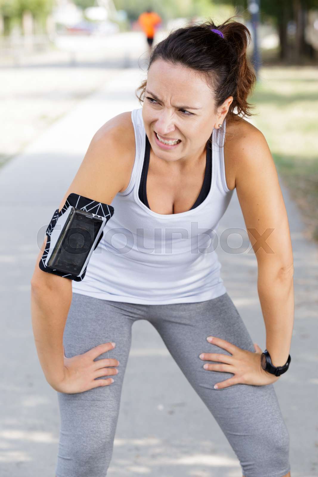 woman stopping to grab some air after working-out outdoors | Stock ...