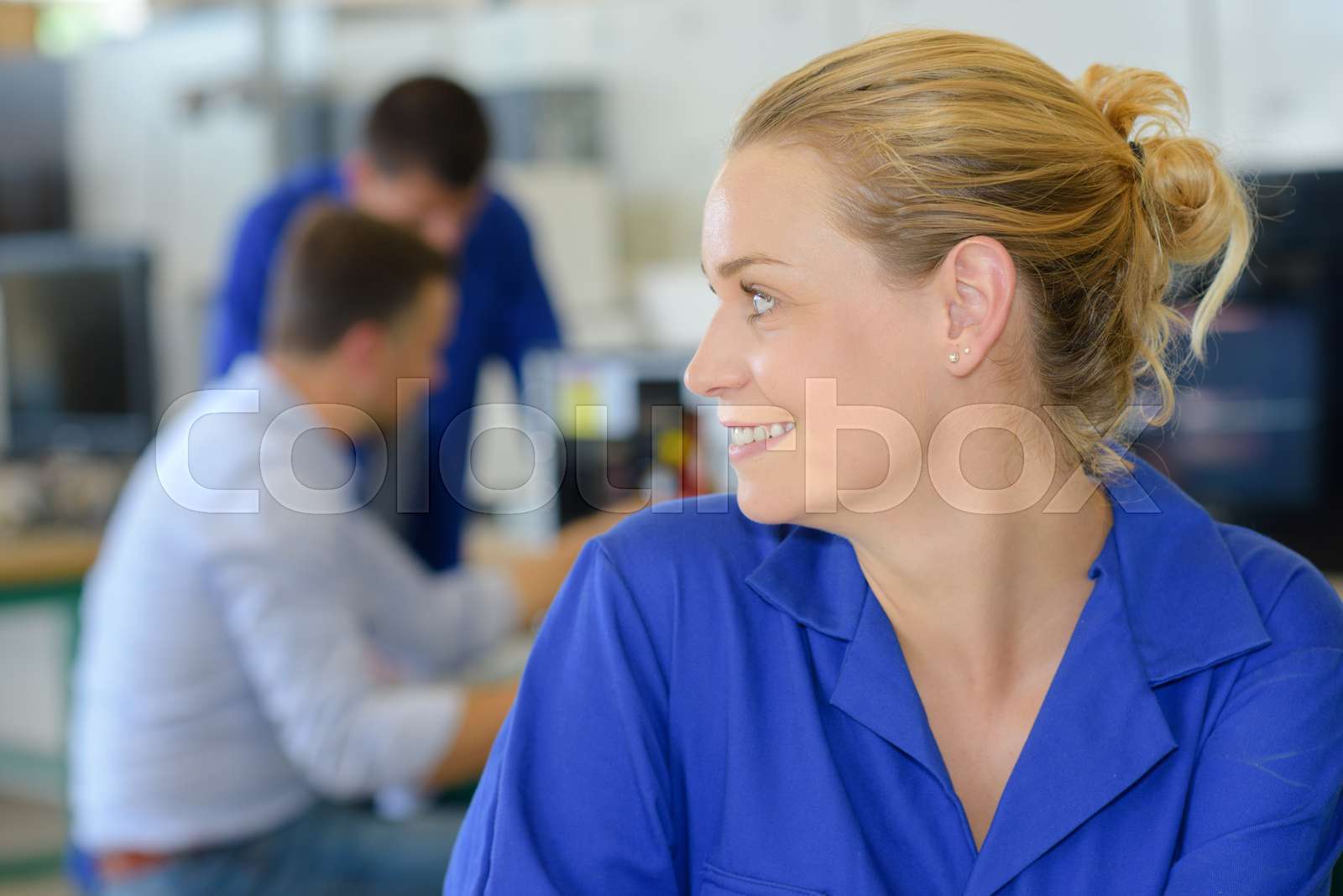 Smiling female apprentice in profile | Stock image | Colourbox