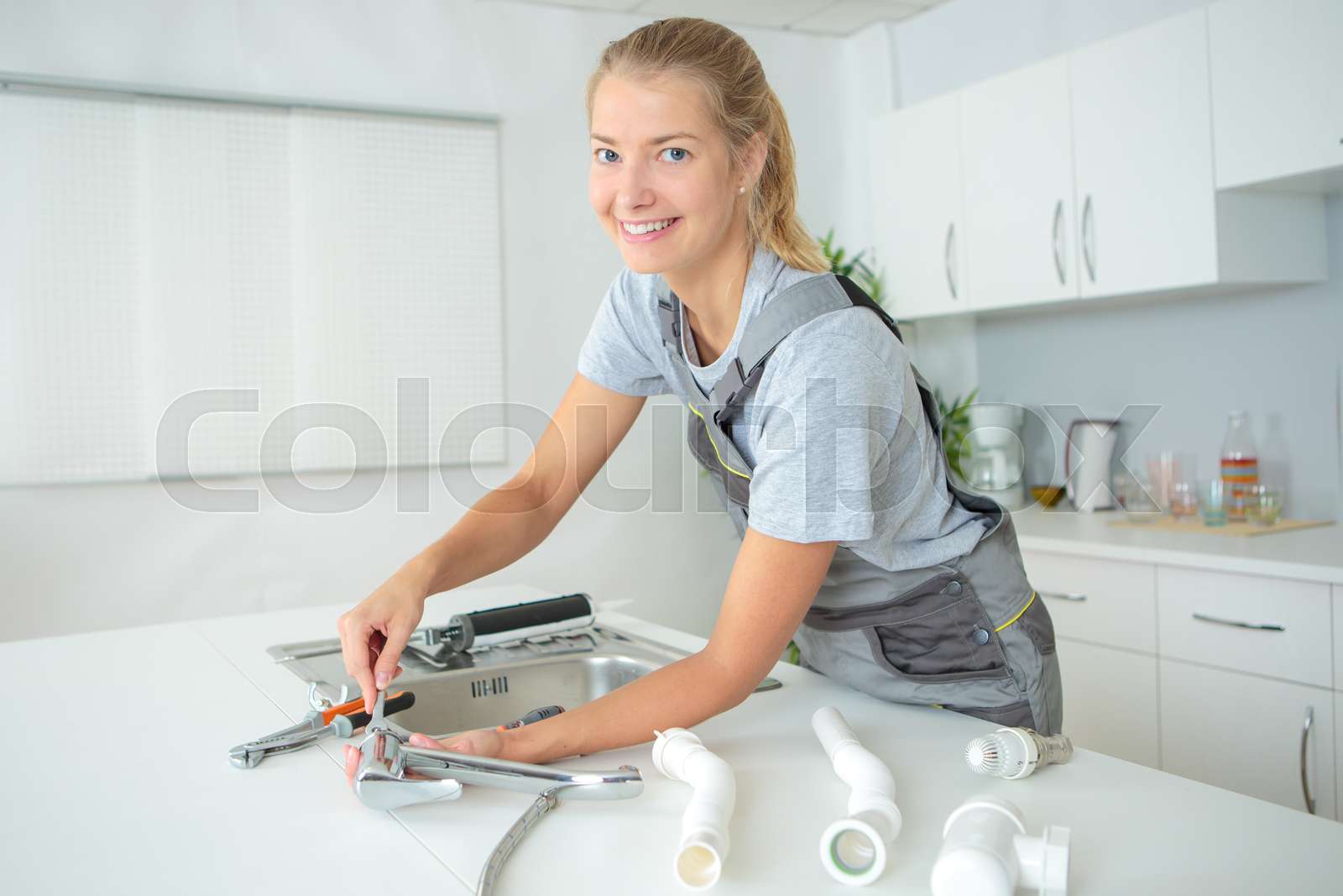 a woman plumber is smiling | Stock image | Colourbox