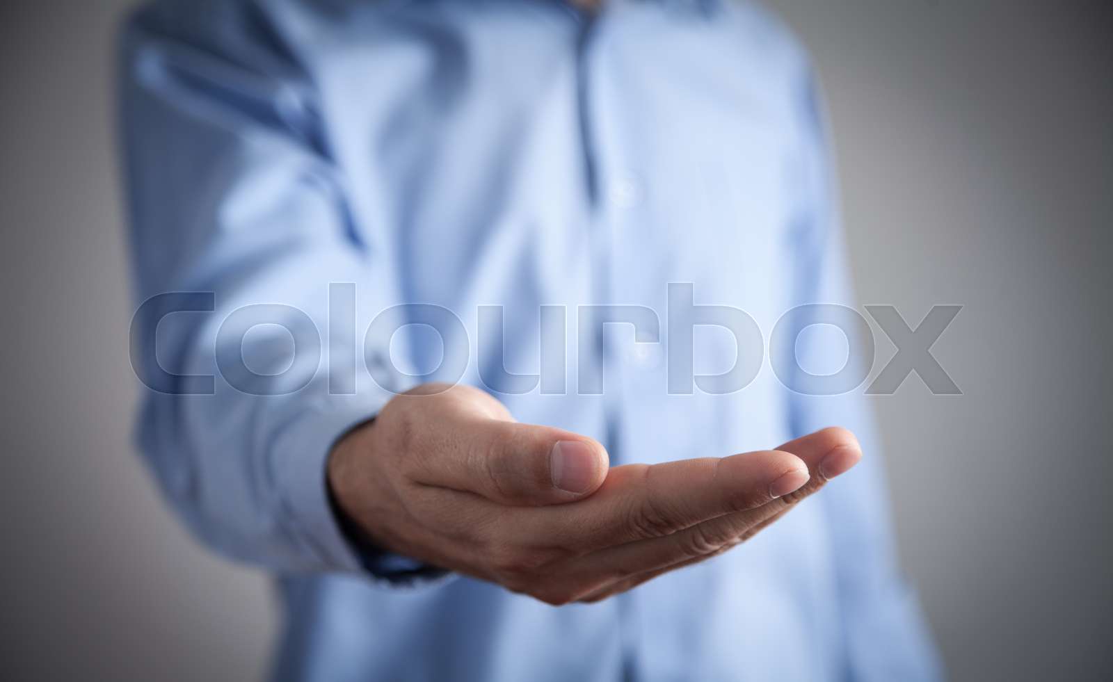 Man showing empty hand. Giving gesture | Stock image | Colourbox