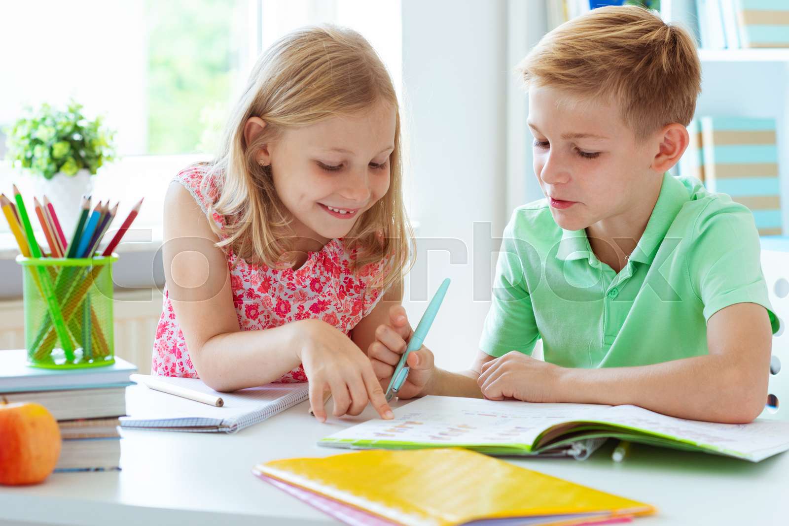 Schoolchildren are came back to school and learning at the table in ...