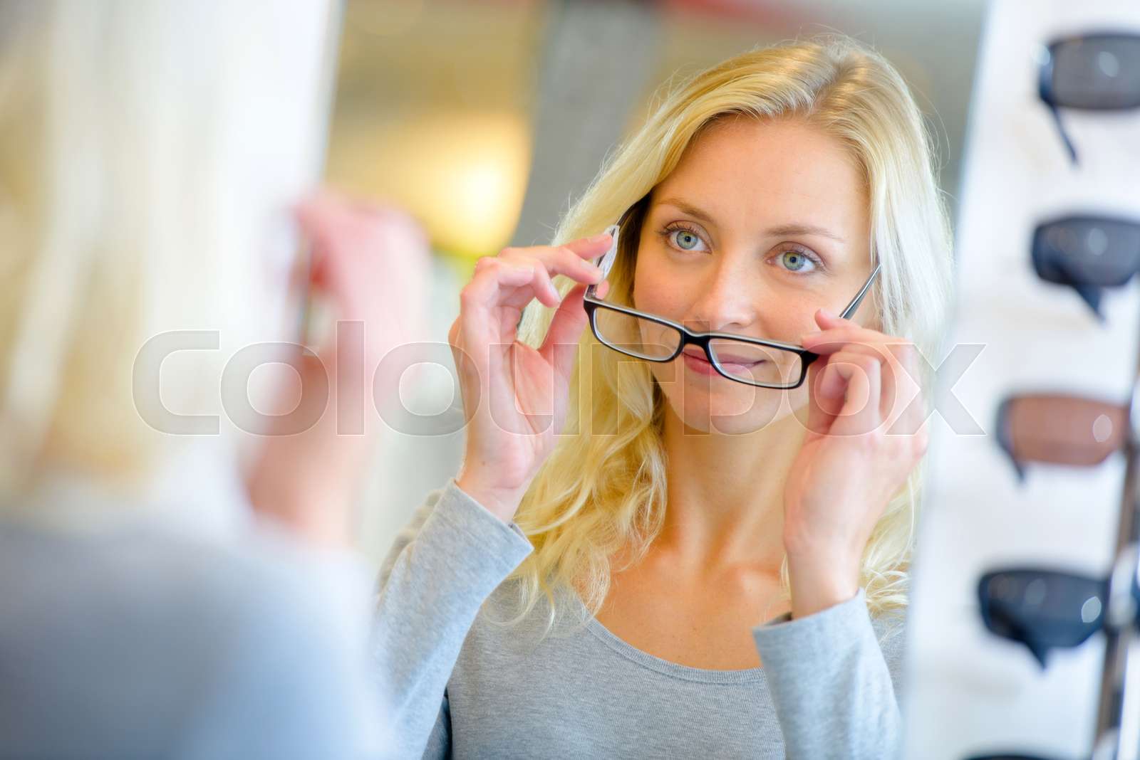 woman fitting a pair of eyeglasses | Stock image | Colourbox