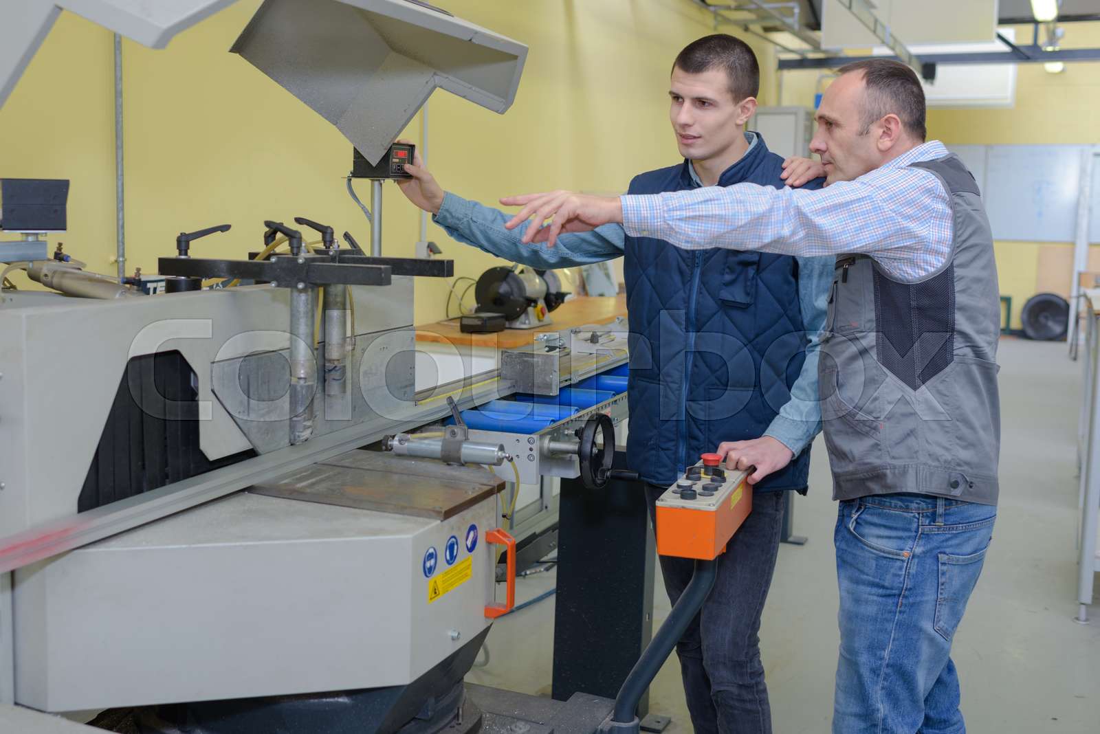 engineer training apprentices on cnc machine | Stock image | Colourbox