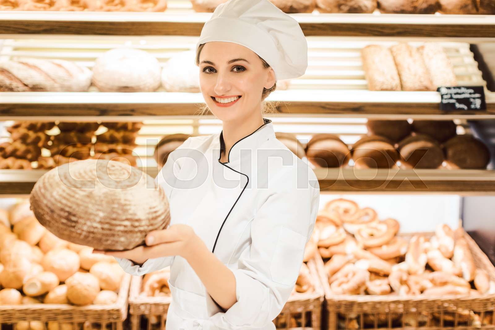 Beautiful woman selling bread in bakery | Stock image | Colourbox