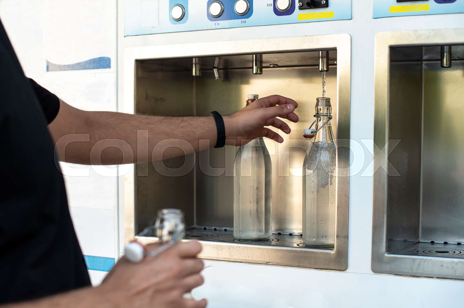 Mineral Water machine on the street. Pay and load drinking water ...