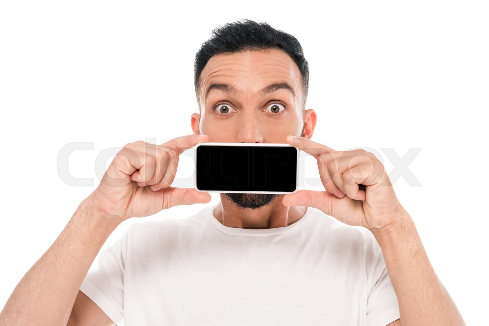 shocked man looking at camera and covering face with smartphone ...