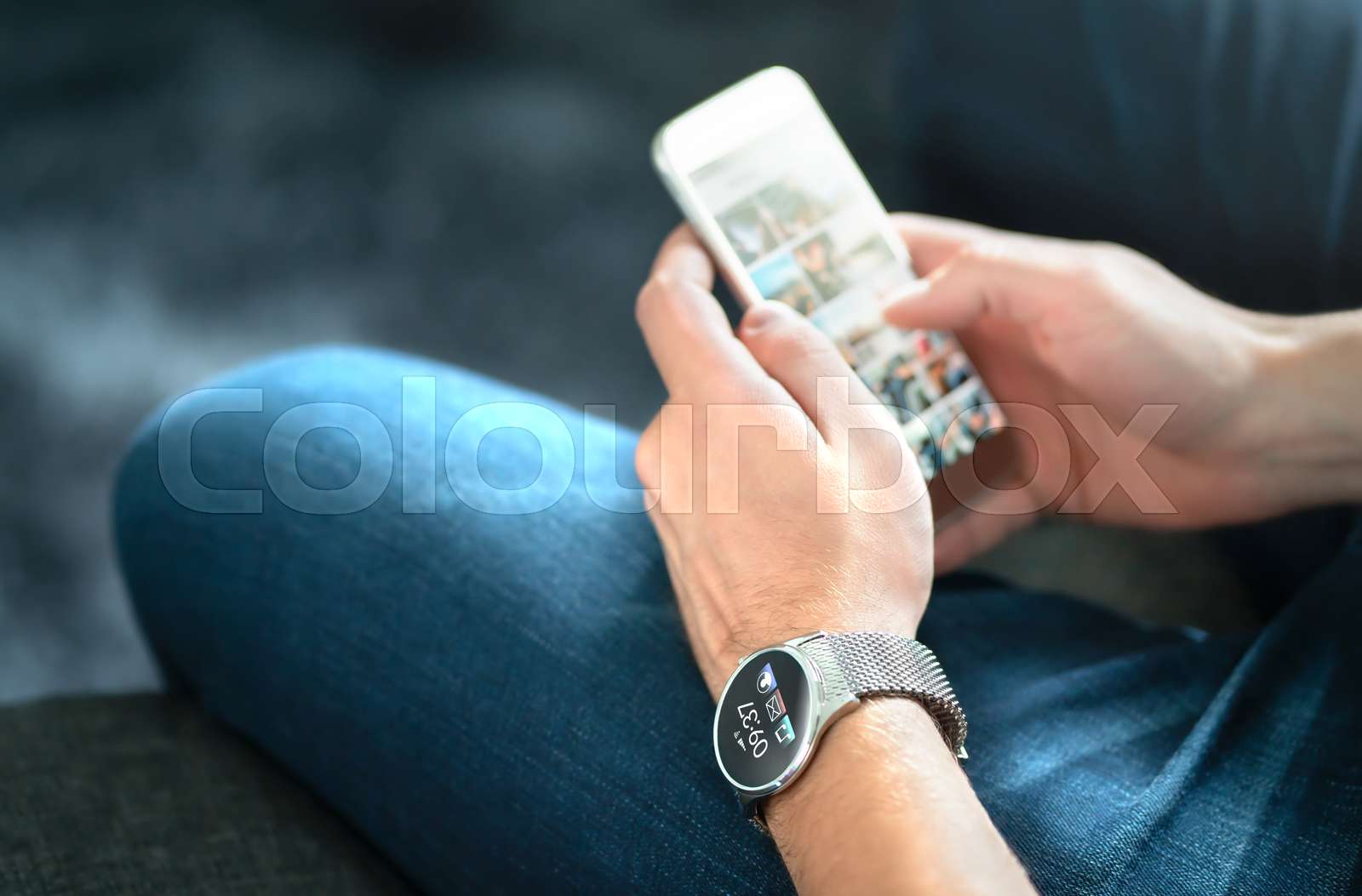 Wireless connection between smart watch and mobile phone. Man using ...