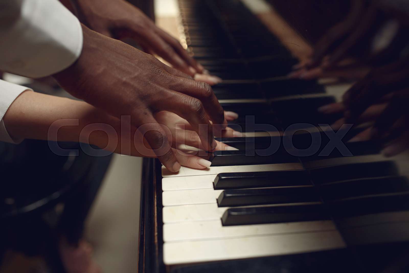 Black grand piano player hands on the keys | Stock image | Colourbox