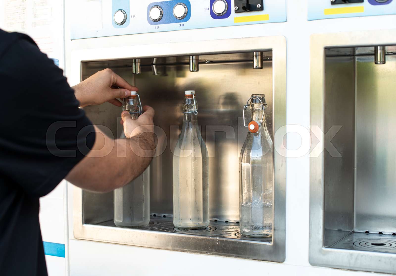 Mineral Water machine on the street. Pay and load drinking water ...