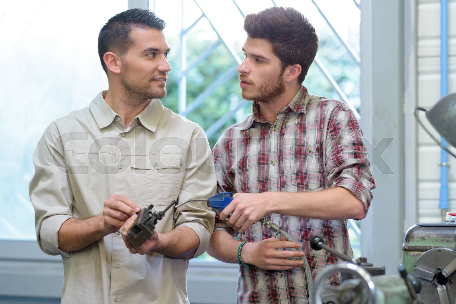 young welding apprentice and his teacher talking | Stock image | Colourbox