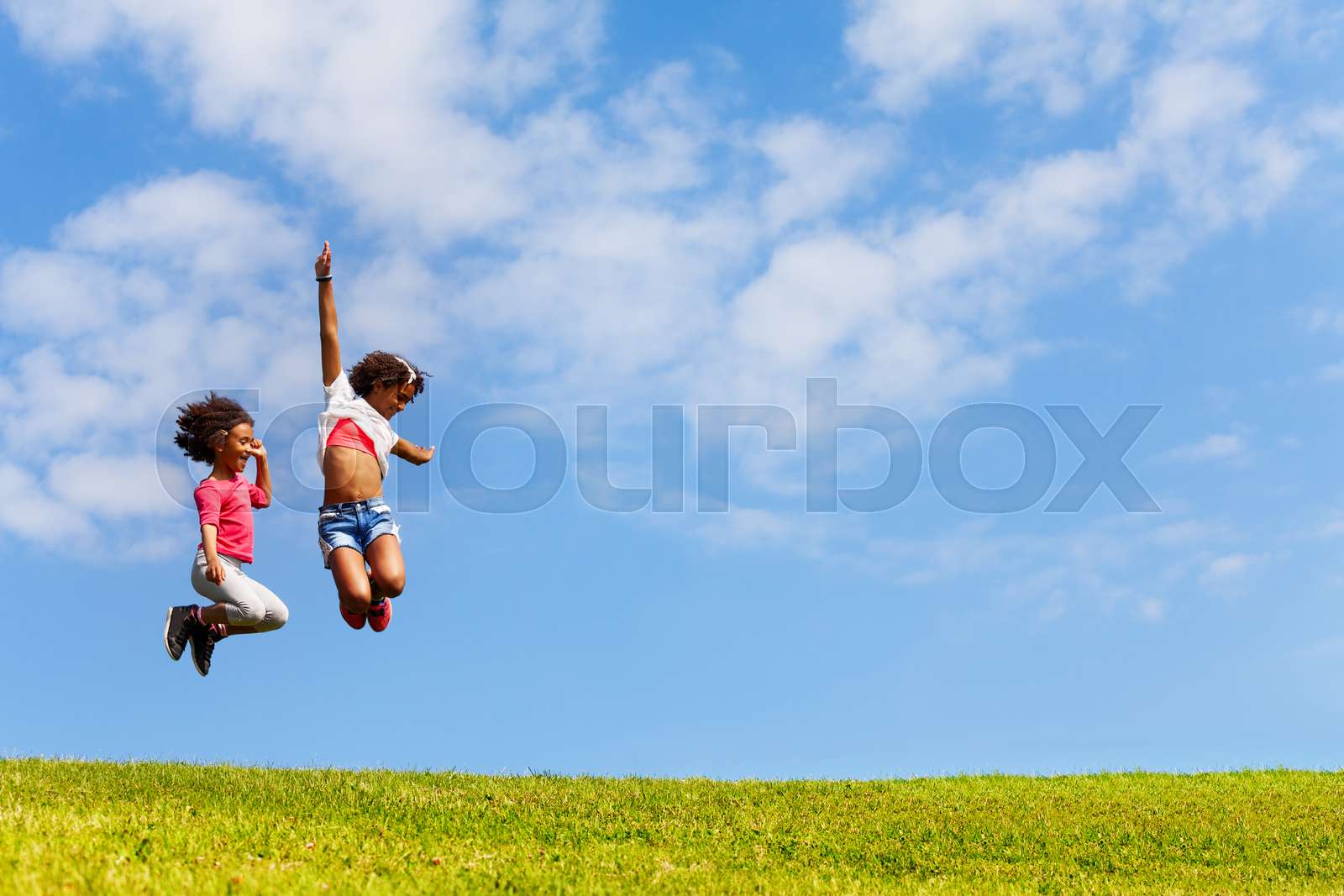Cute cool looking beautiful girls jump high | Stock image | Colourbox