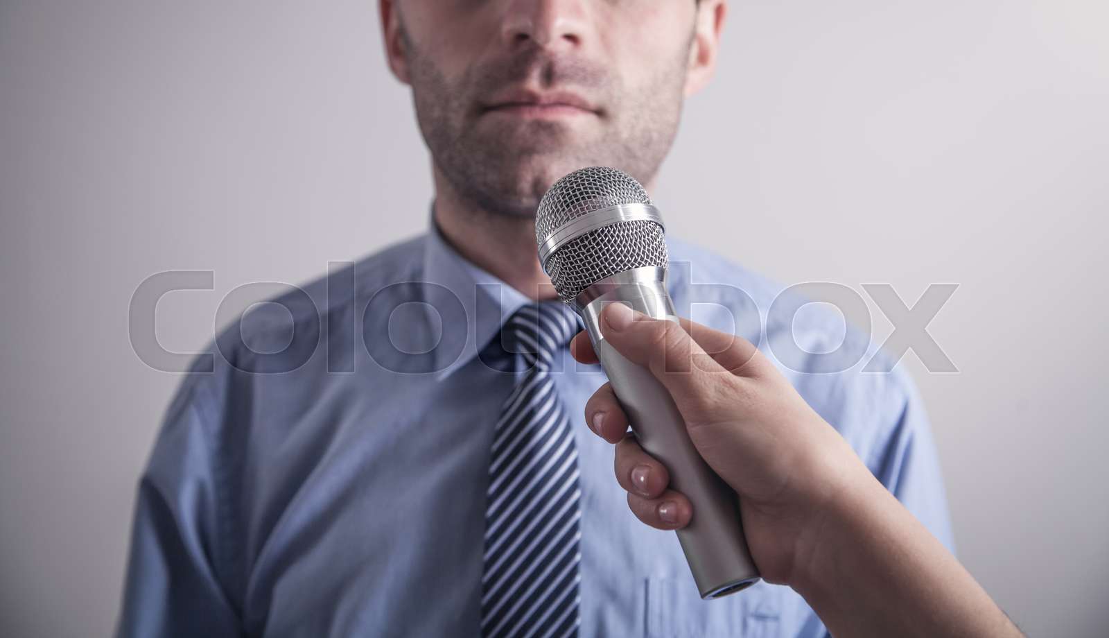Journalist with microphone making interview. | Stock image | Colourbox