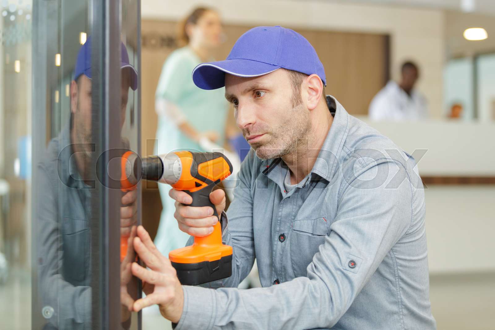 handyman using a drill in hospital | Stock image | Colourbox
