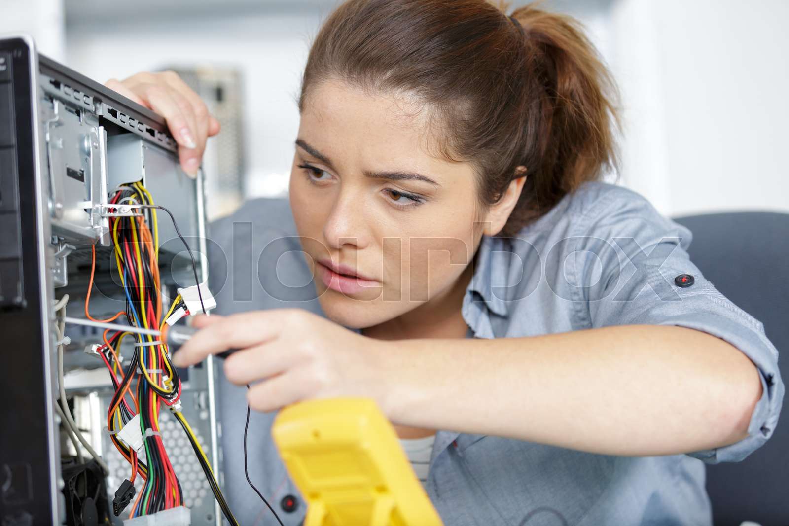 young female pc technician learning to fix a computer | Stock image ...