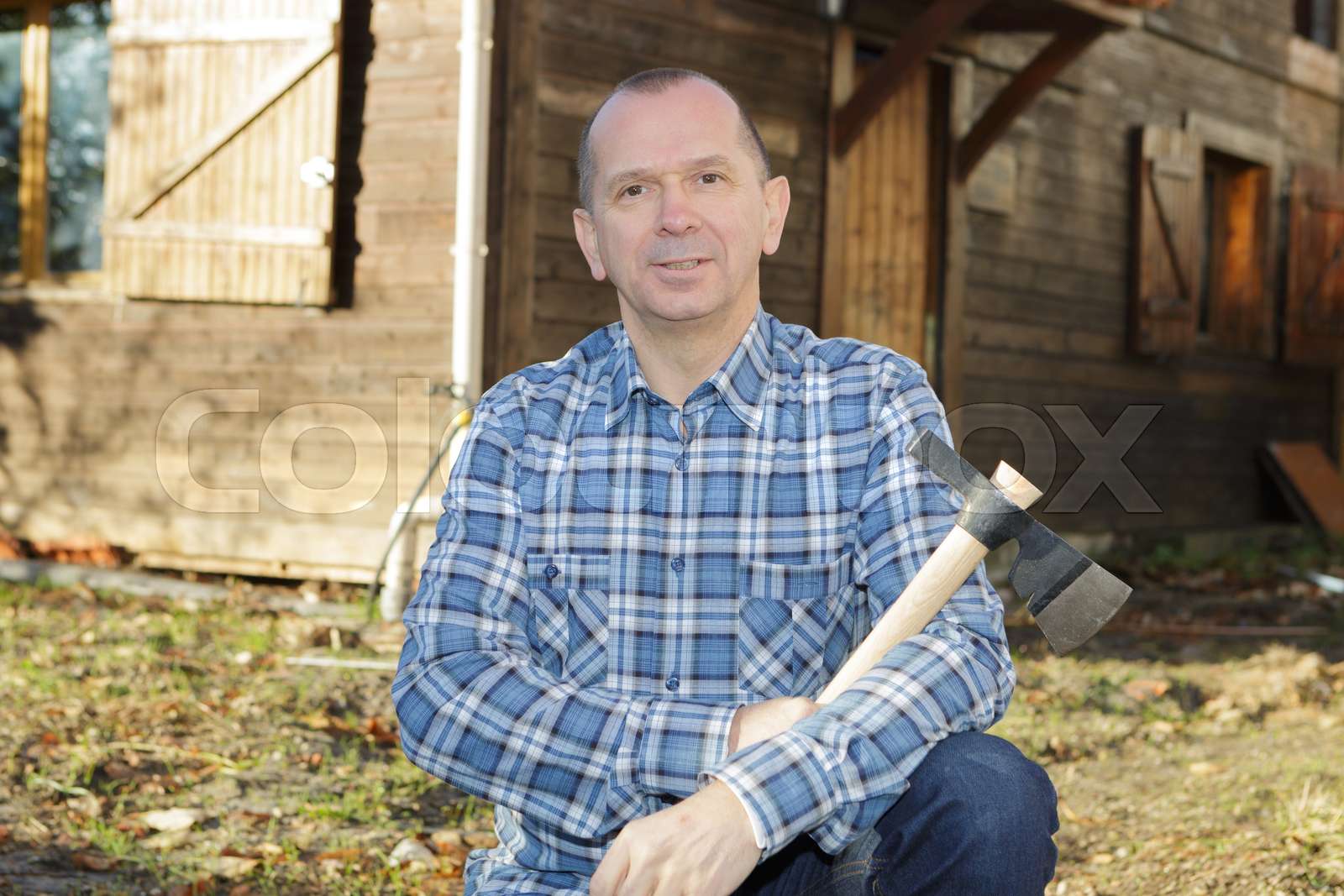 man holding an ax posing | Stock image | Colourbox