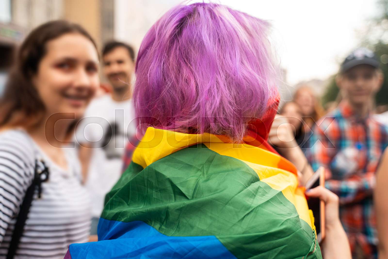 Girl with pink hair and an LGBT flag at a rally | Stock image | Colourbox