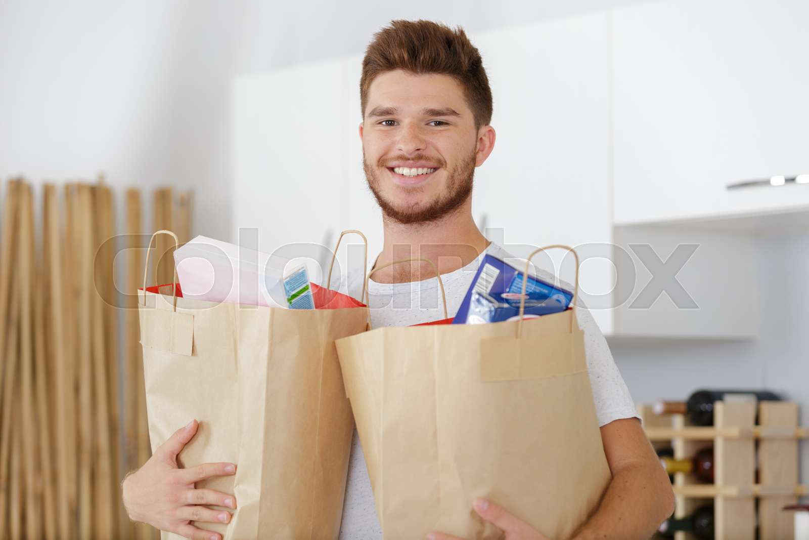 man with a bag of groceries shopping | Stock image | Colourbox