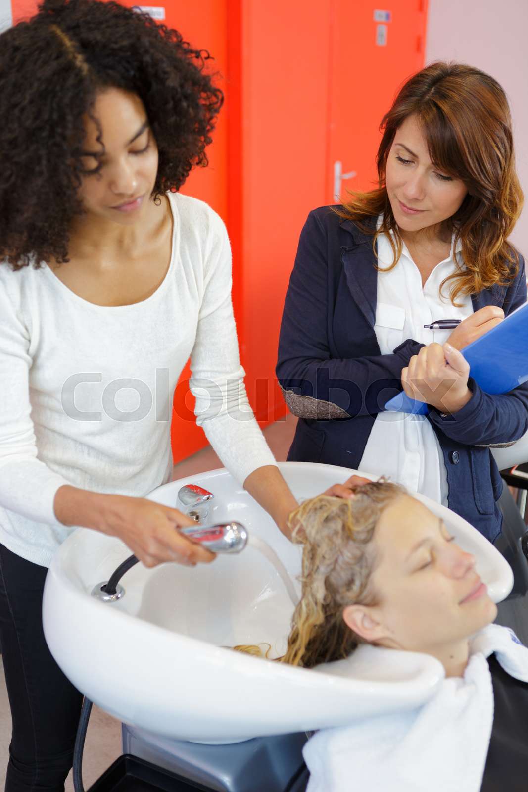 hairdressing junior being supervised washing customershair | Stock ...