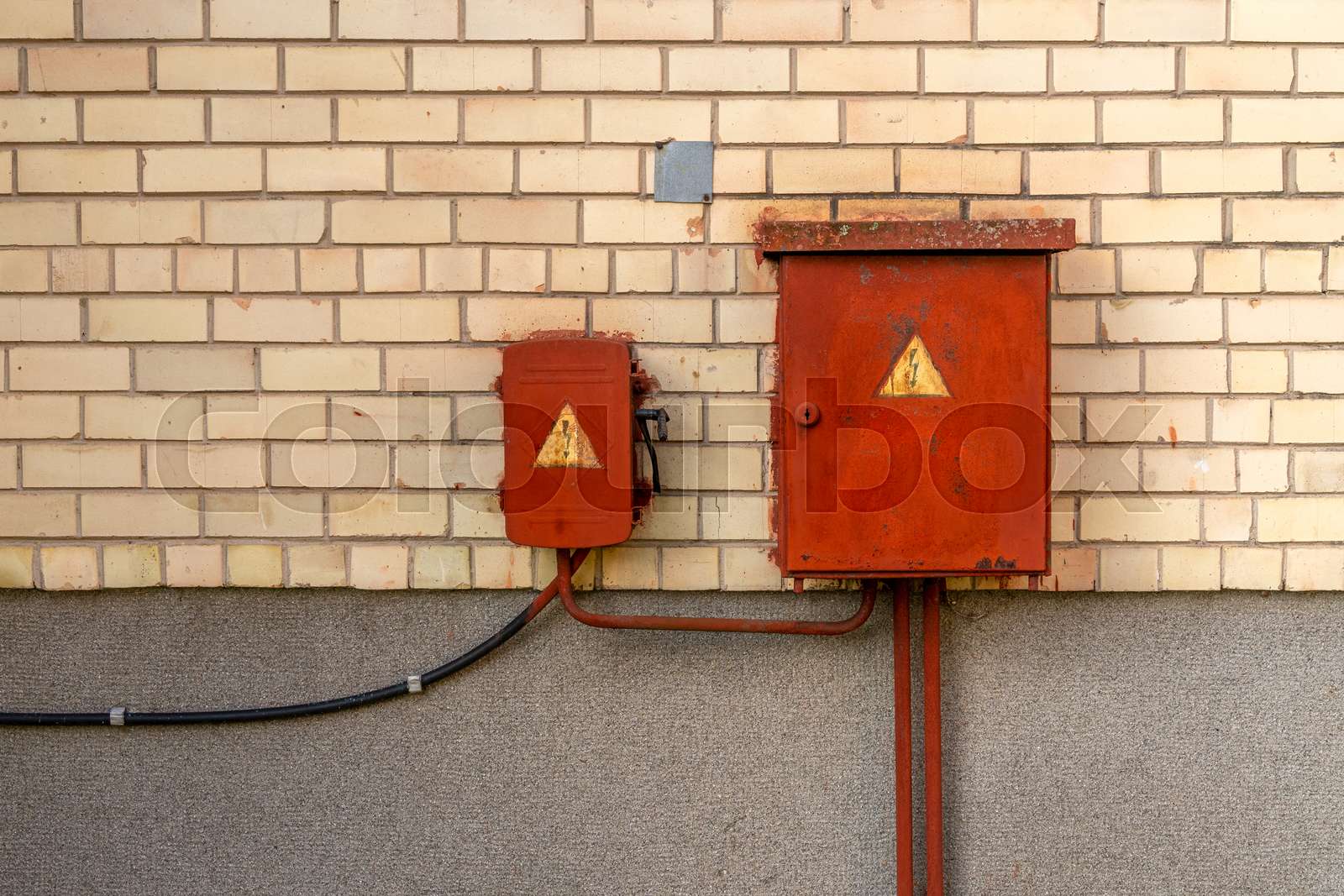Rusty power supply box on the brick wall | Stock image | Colourbox