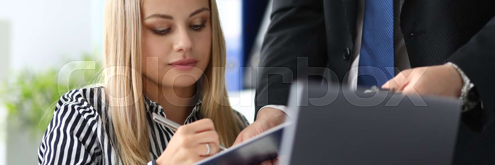 Beautiful business lady signing documents | Stock image | Colourbox