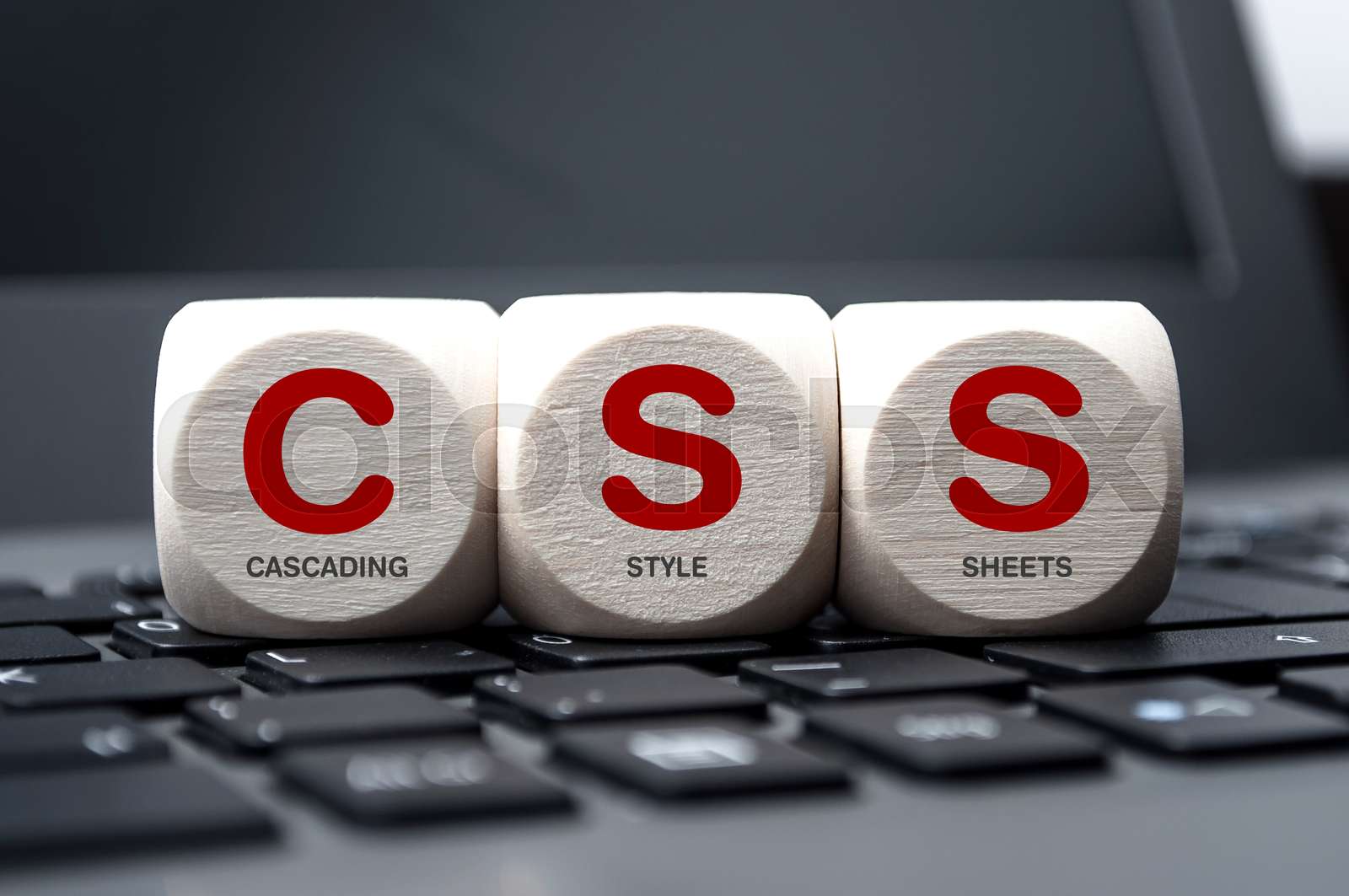 Cubes and dice on laptop keyboard with CSS cascading style sheets ...