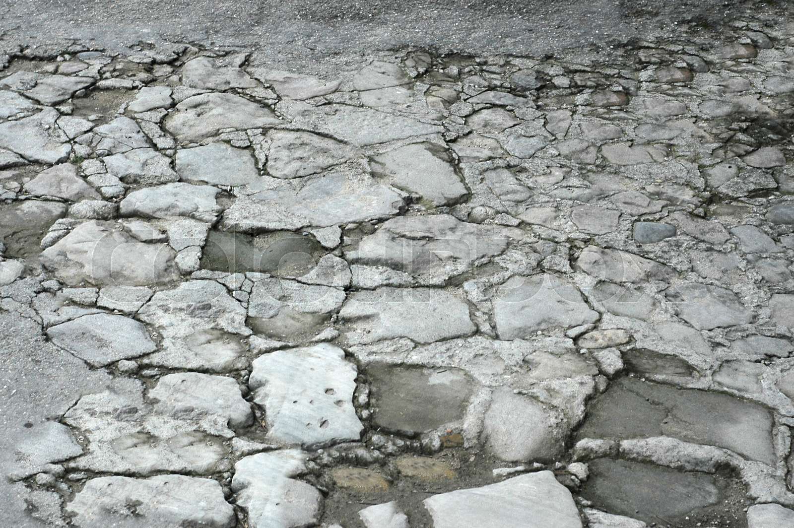 Asphalt road with a broken surface and cracking | Stock image | Colourbox