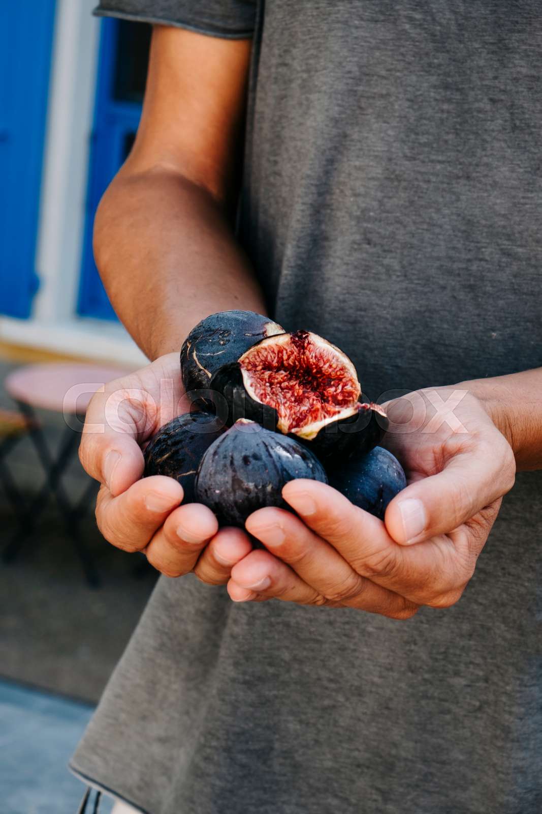 man with some figs in his hands | Stock image | Colourbox
