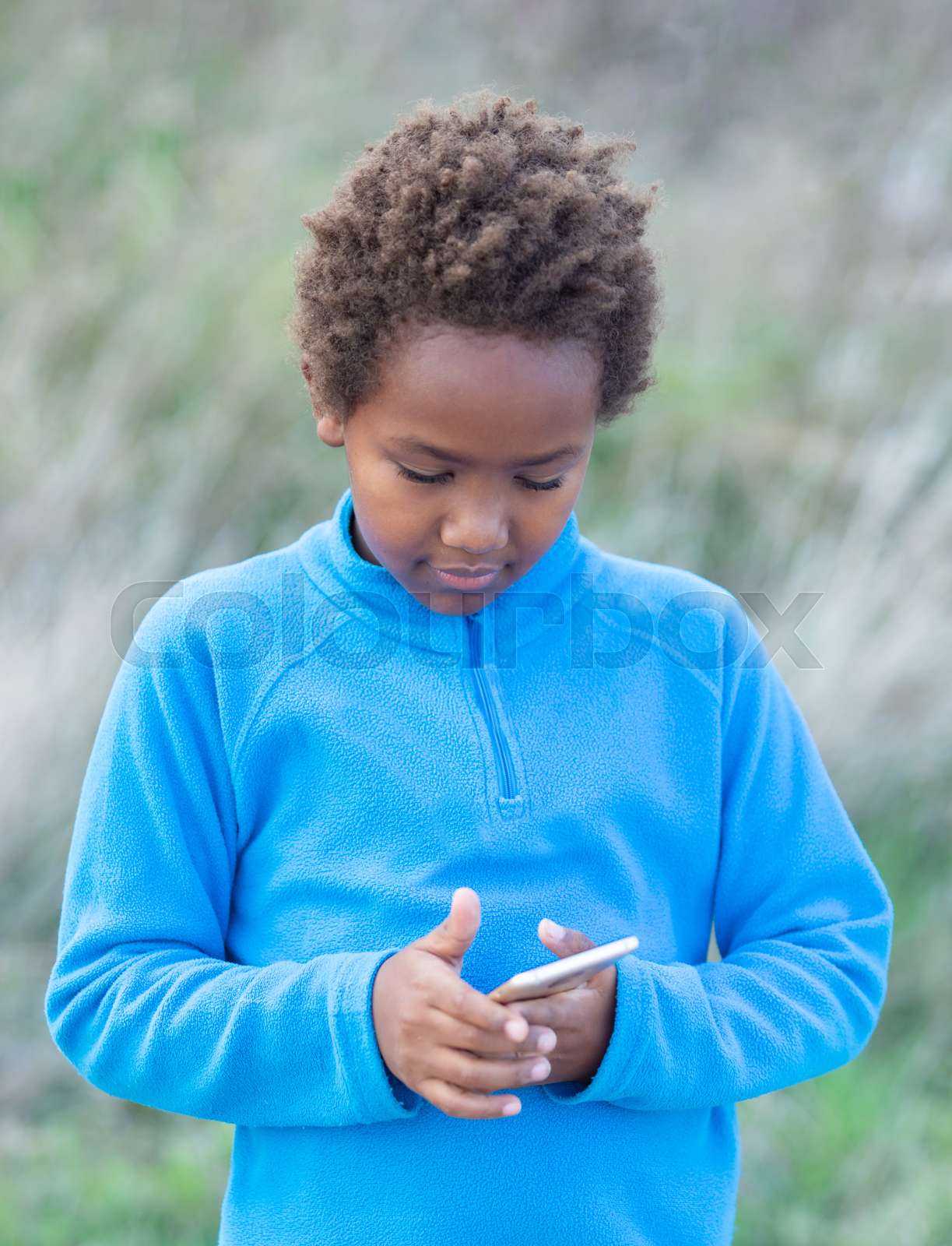 Adorable african child with a mobile phone | Stock image | Colourbox