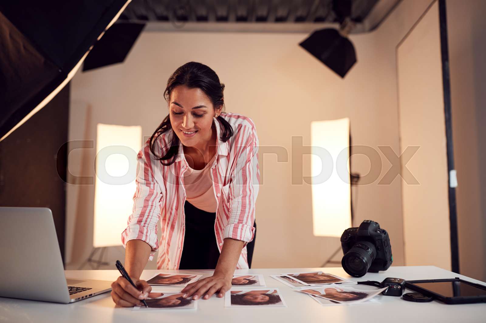 Female Photographer Editing Images From Photo Shoot In Studio | Stock ...