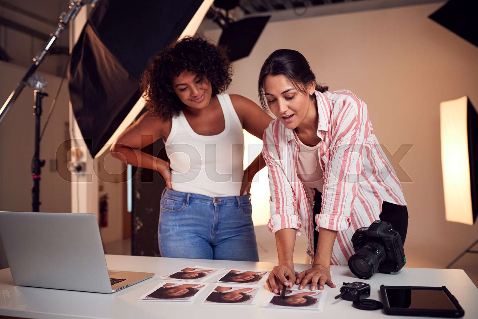 Photographer With Female Client Editing Images From Portrait Photo ...