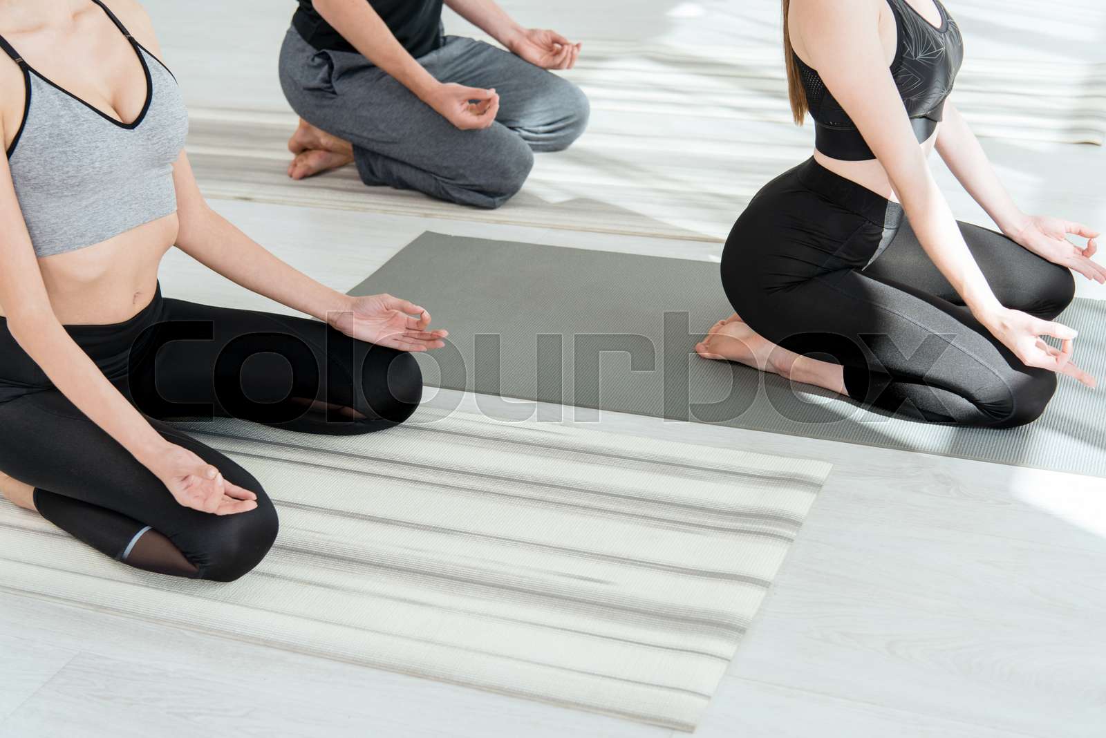 1cropped view of women practicing yoga in diamond pose | Stock image ...