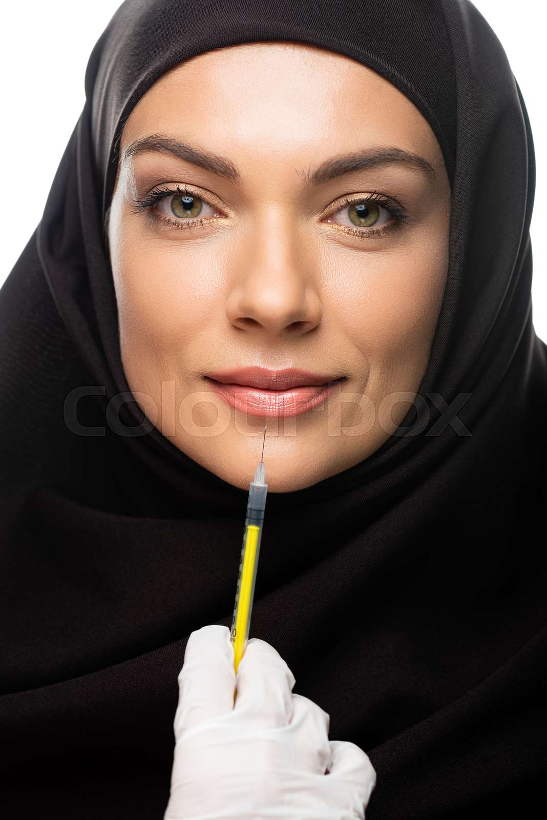 young Muslim woman in hijab having beauty injection isolated on white ...