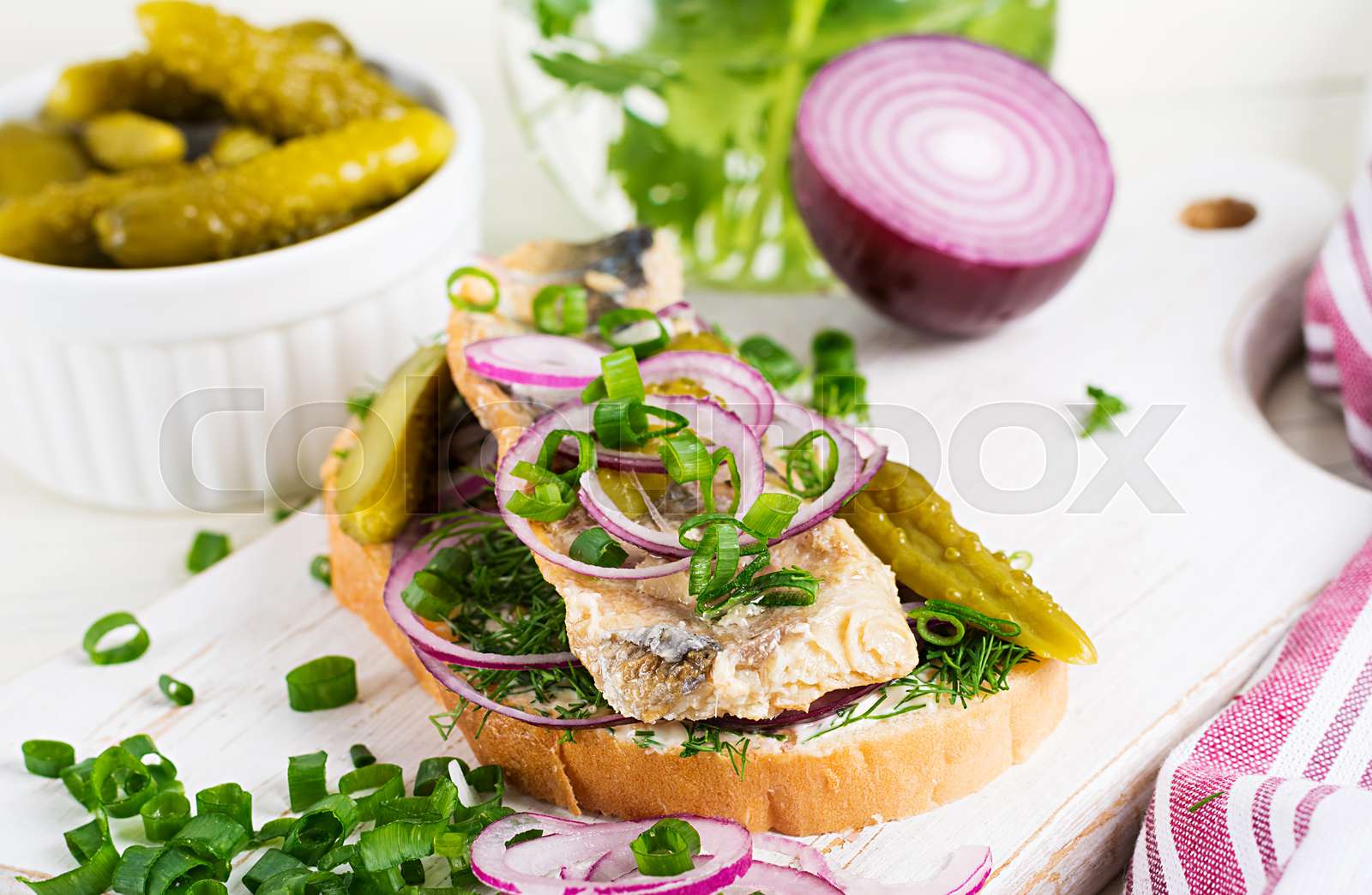 Traditional Dutch sandwich with herring and pickles cucumbers on white ...