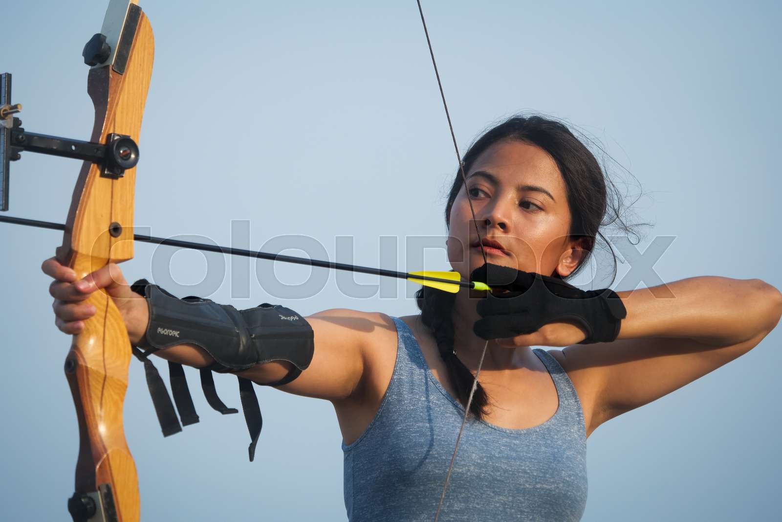 Asian Archery woman with bow shooting on the beach | Stock image ...