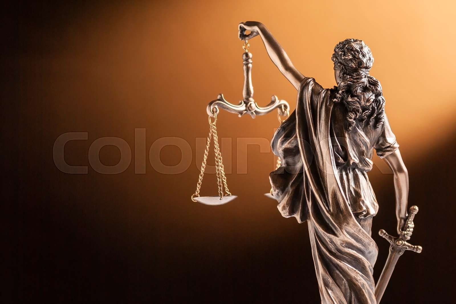Rear view of Justice holding up scales | Stock image | Colourbox