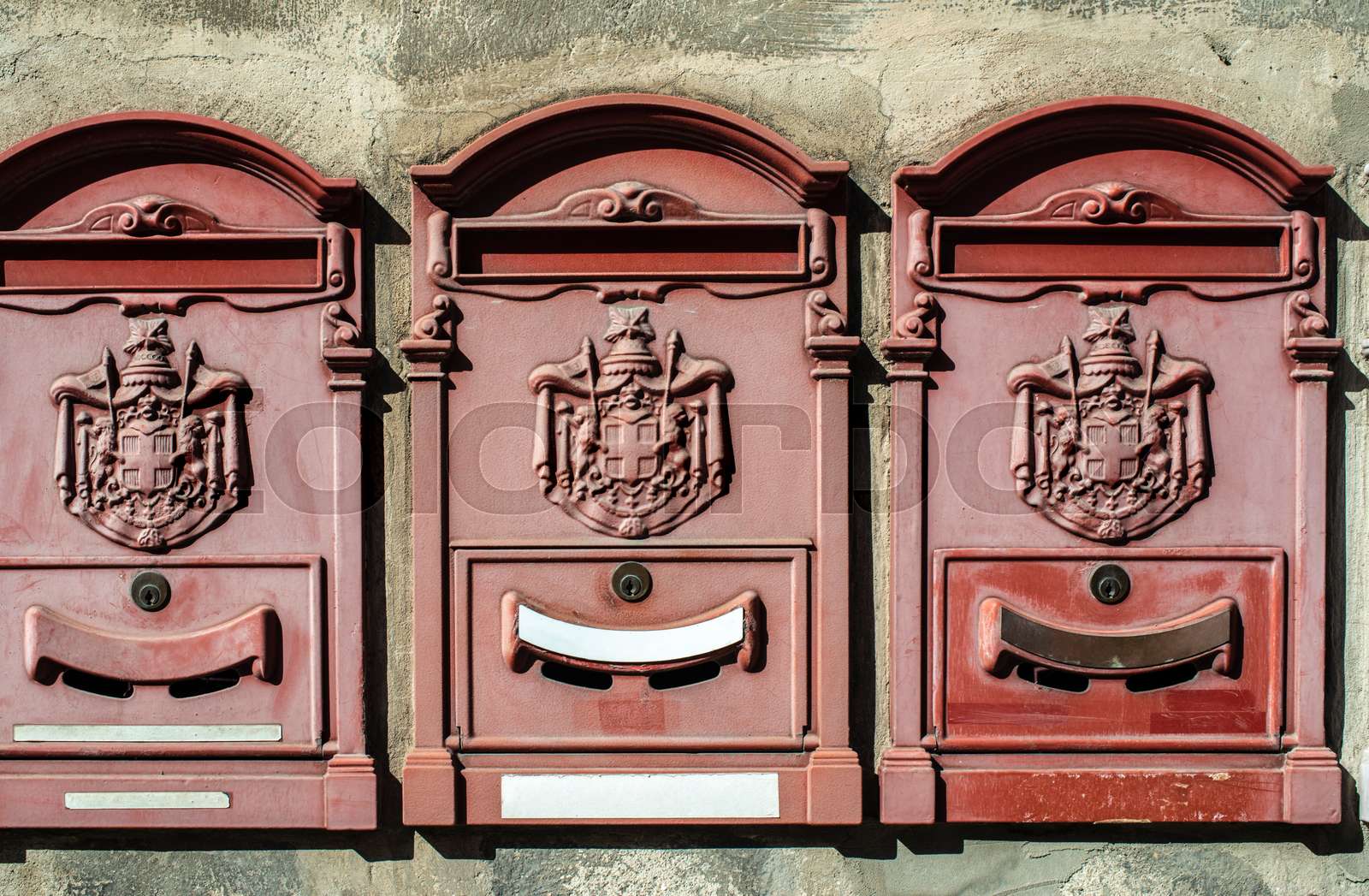 Old vintage mailboxes in Italy. Metal red mailboxes on grey facade ...