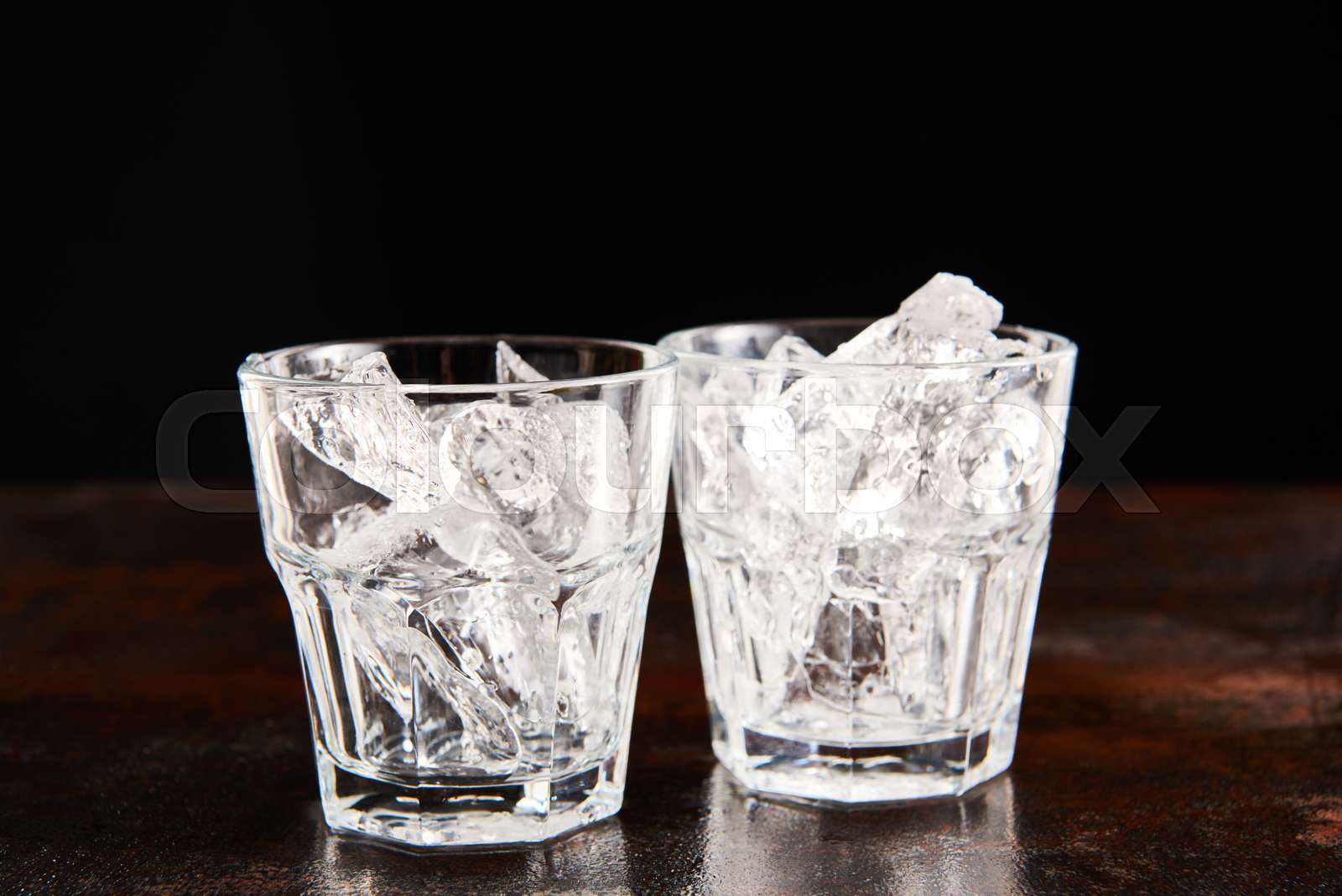 glass with frosted ice cubes isolated on black | Stock image | Colourbox
