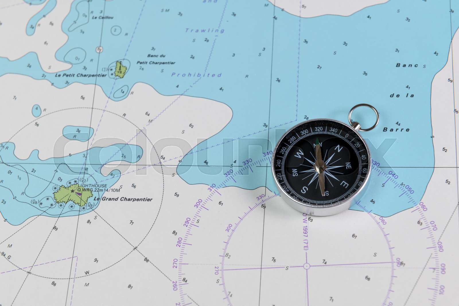 Magnetic compass on a nautical navigational map | Stock image | Colourbox