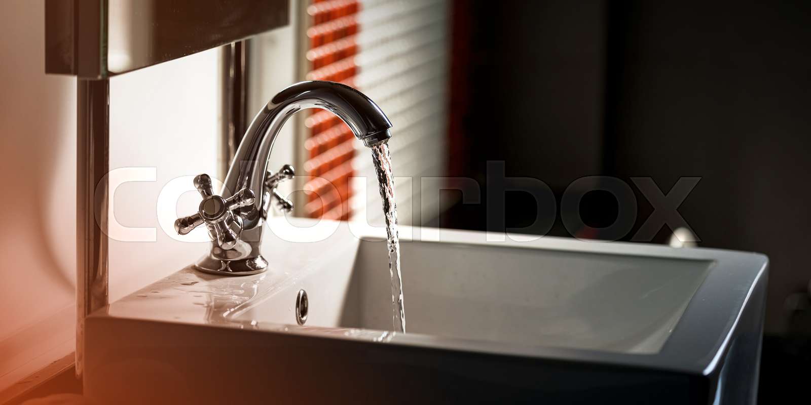 Faucet and water flow on bathroom | Stock image | Colourbox
