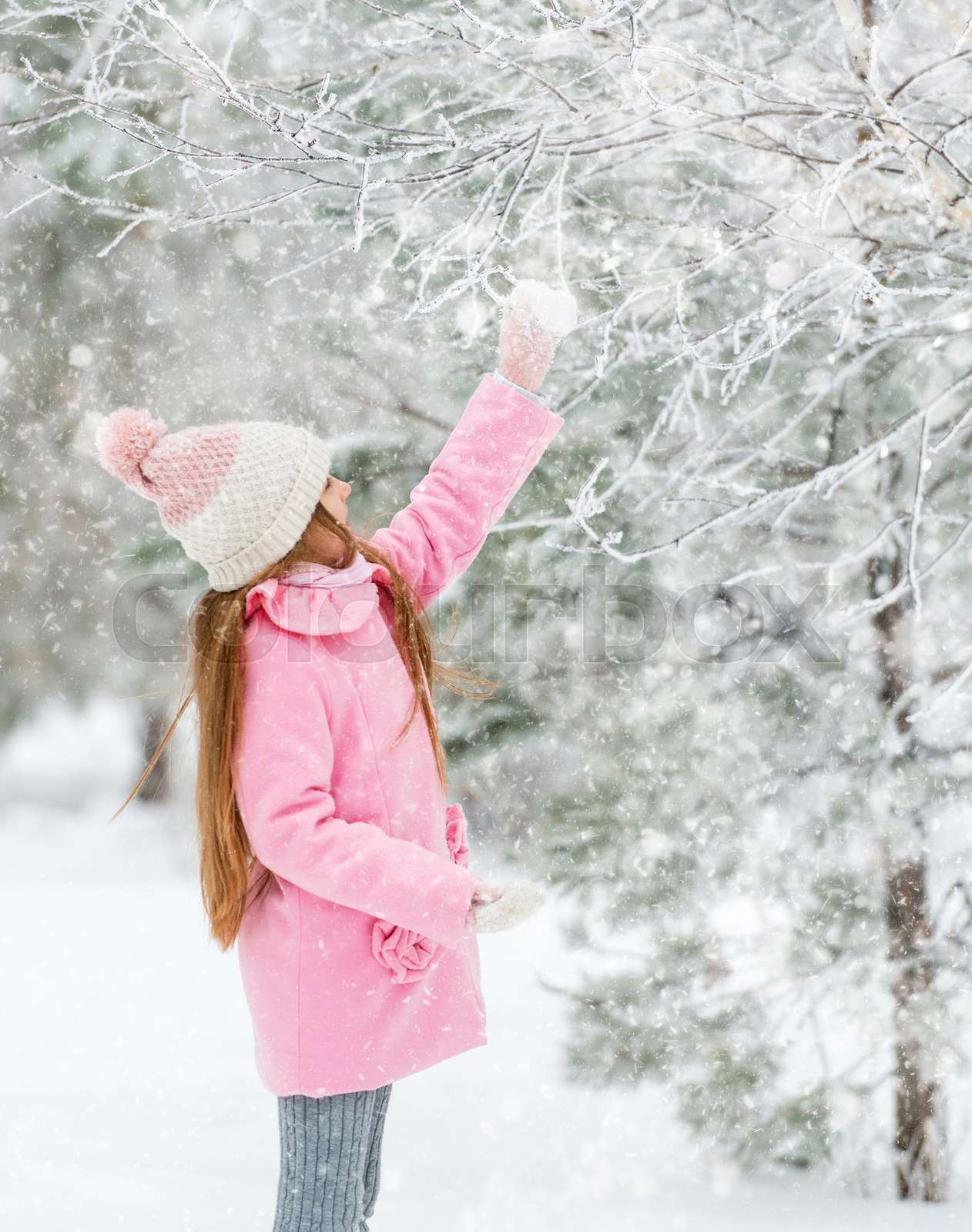 Child touching a tree, sideview | Stock image | Colourbox
