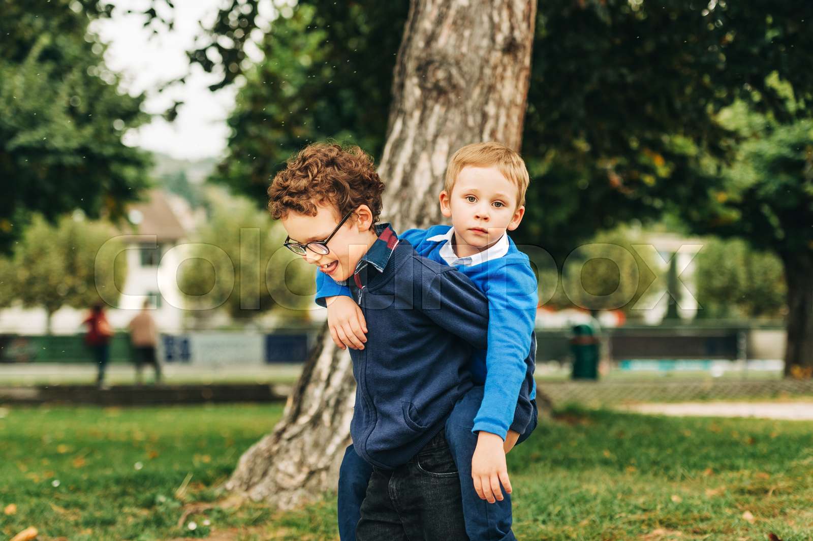 Two funny brothers playing together outside, elder brother caring ...
