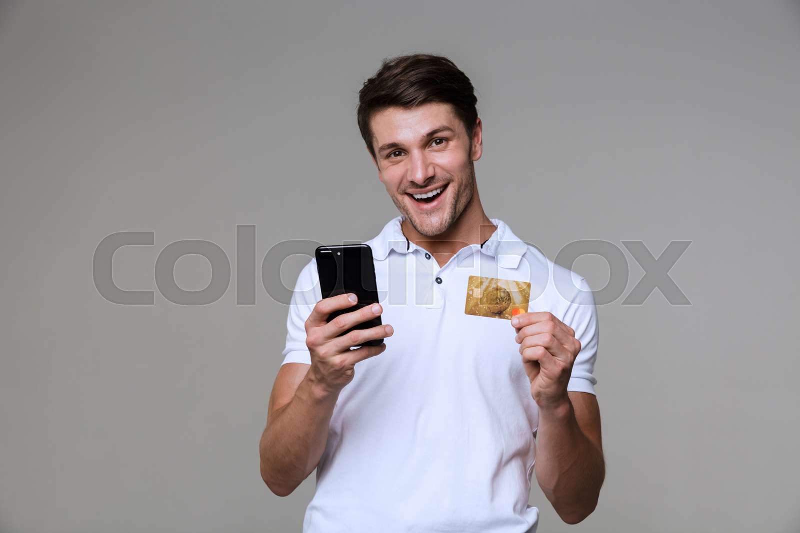 Man posing isolated using mobile phone. | Stock image | Colourbox