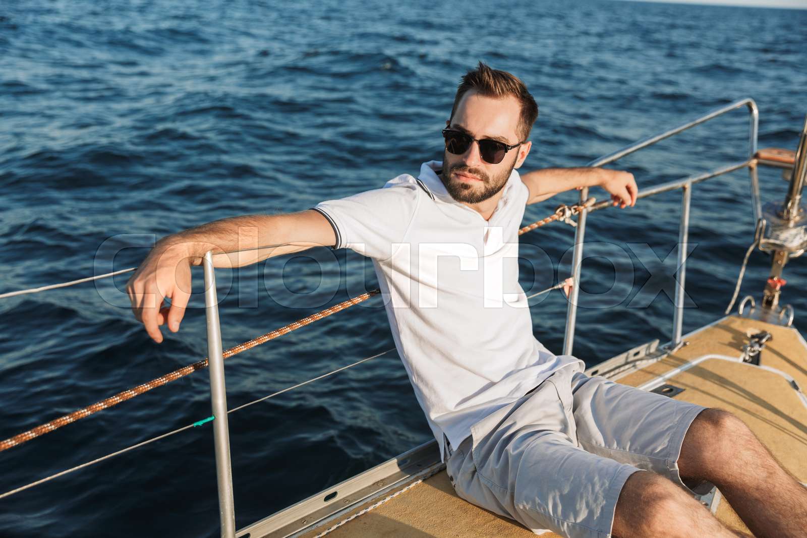 Man outdoors posing on yacht in sea. | Stock image | Colourbox